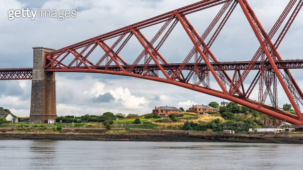 Red metal bridge built many years ago to access the city of Edinburgh ...