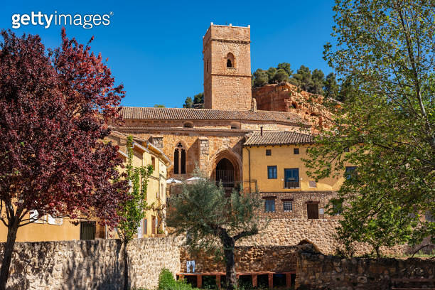Church tower and medieval buildings of the pretty picturesque village ...