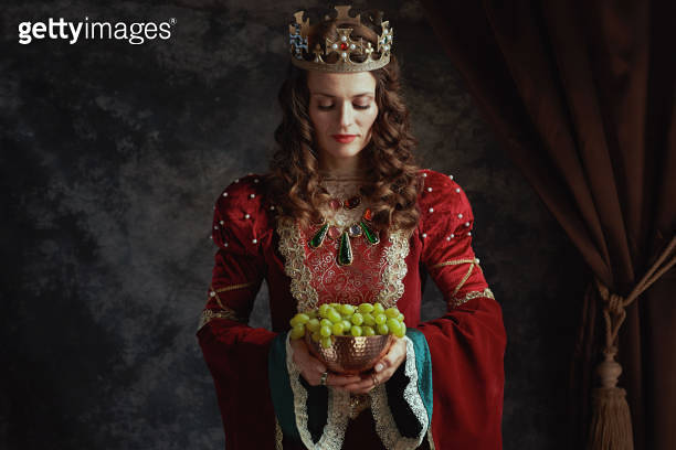 medieval queen in red dress with plate of grapes and crown (1502314666 ...