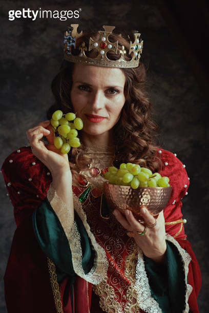medieval queen in red dress with plate of grapes and crown (1494564901 ...