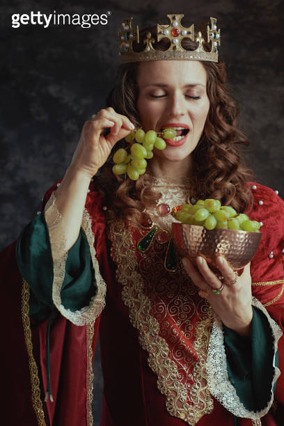 medieval queen in red dress with plate of grapes and crown (1475063220 ...