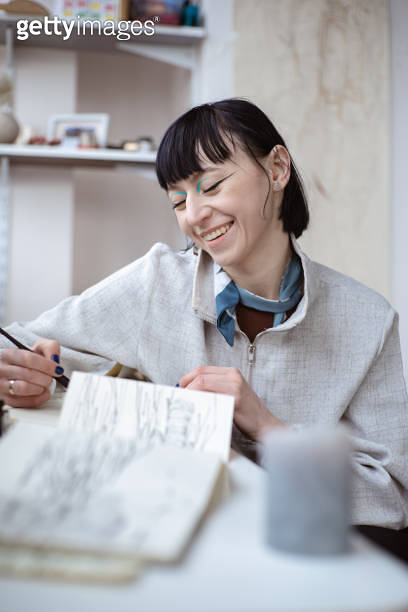 female artist look at her work drawing with pen and black ink. Graphic ...