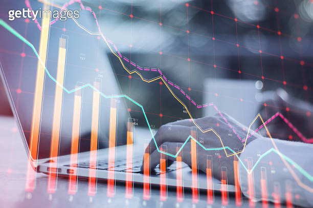 Close up of hands using laptop with downward red crisis chart grid on ...