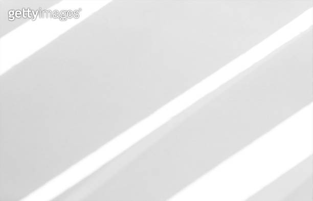 Shadow Striped diagonal sun light reflection from window on white wall ...