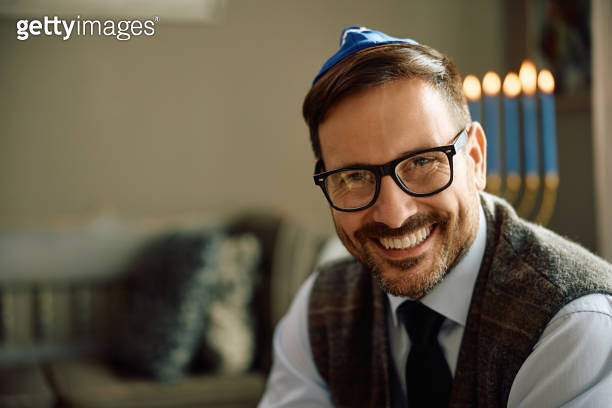 Happy Jewish man at home on Hanukkah looking at camera. (1756050490 ...