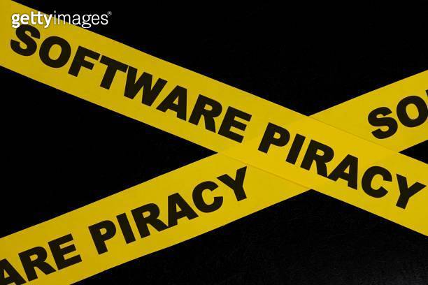 Software piracy alert, caution and warning concept. Yellow barricade ...