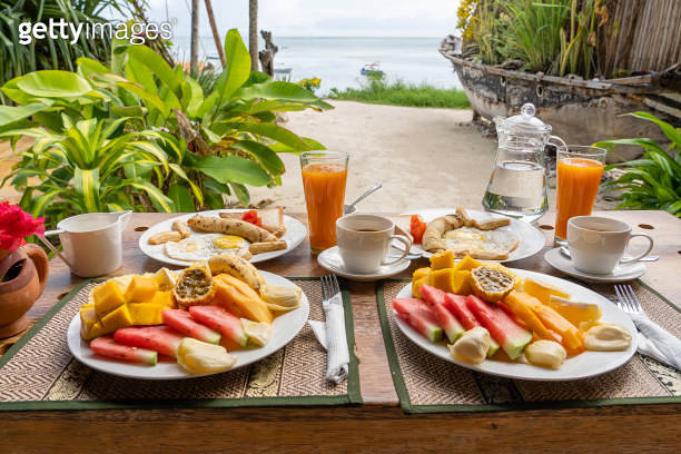 Tropical breakfast of fruit, coffee and scrambled eggs and banana ...