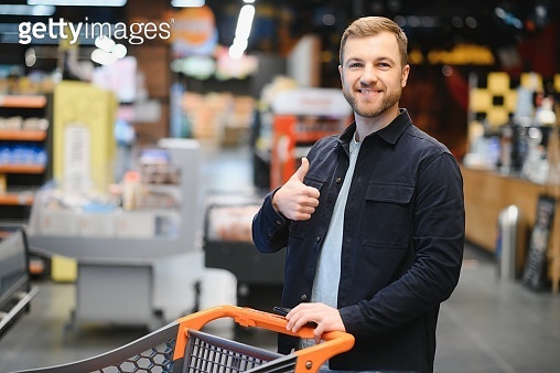 Customer In Supermarket. Man Doing Grocery Shopping Standing With Cart ...