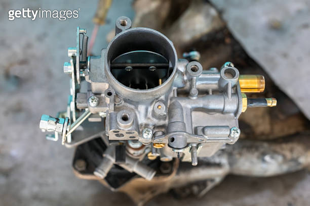 View of automobile carburetor. A carburetor (also spelled carburettor ...