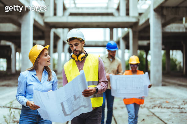 Comparing with the blueprints, a team of experts is evaluating the ...
