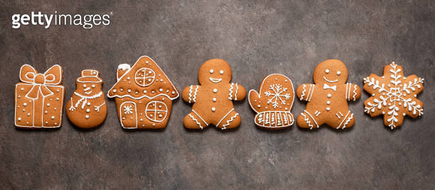 Collection of Christmas gingerbread cookies in a row on a dark ...