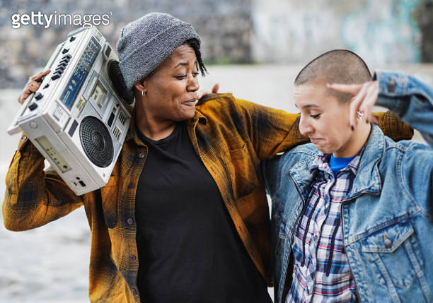 Young multiracial female street musicians rapping in the city - Focus ...