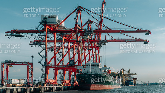 Port Crane at sunset. Harbor container terminal with cranes, containers ...