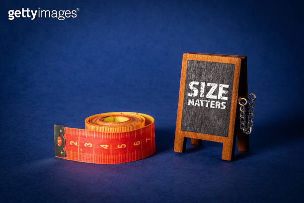 Size Matters. Miniature blackboard with text and measuring tape on a ...