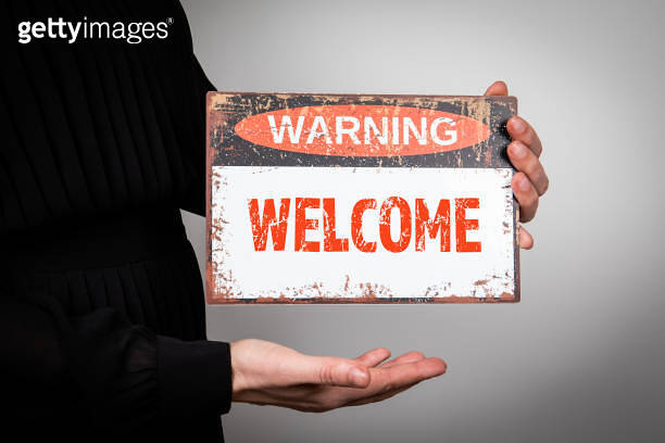 WELCOME. A woman is holding a warning sign with text (1497140646) - 게티이미지뱅크