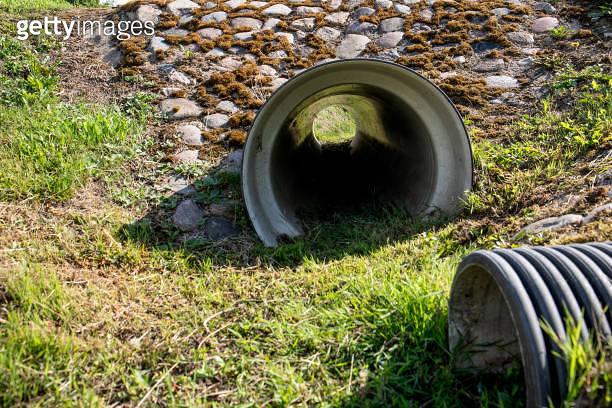 Trough the pipe. Stormwater and road infrastructure ditch (1593048096 ...
