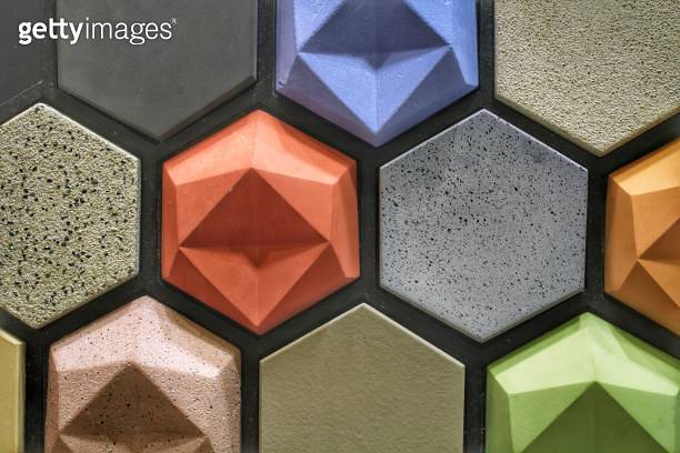 Colorful stone wall with hexagon tile pattern. Geometric texture marble ...