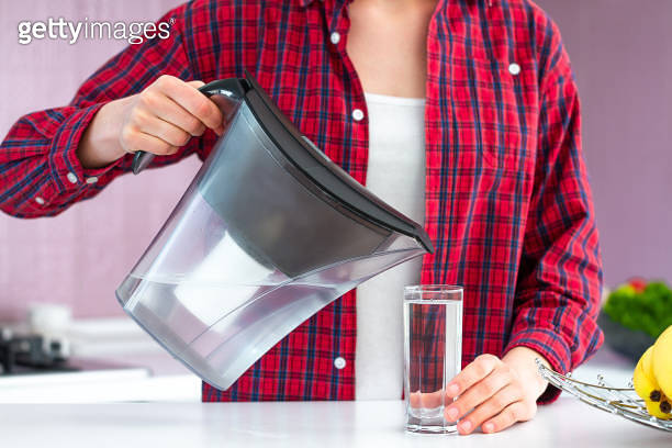 Fresh filtered water from water filter for drink. Healthy lifestyle ...