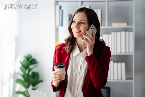 Woman talking on the phone, she is a salesperson in a startup company ...