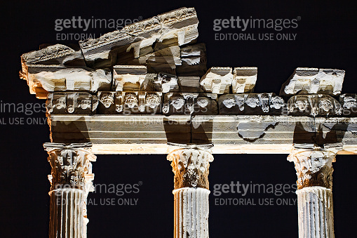 Temple of Apollo, colonnade upper part with frieze close-up at night ...