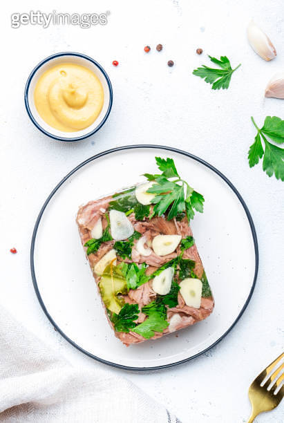 Winter Aspic meat, cold boiled beef in spiced jelly broth on plate with ...