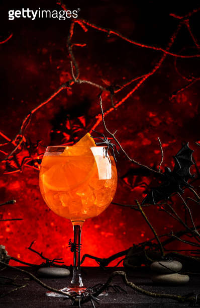 Halloween aperol spritz cocktail on scary dark bloody red background ...