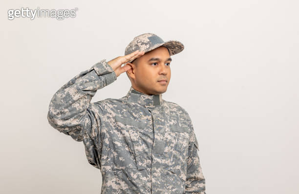 Saluting Asian man special forces soldier standing in studio. Commander ...