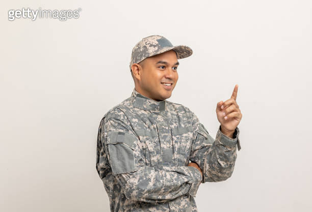 Pointing blank space. Asian man special forces soldier standing in ...
