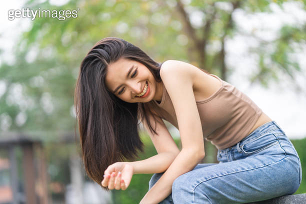 Happy feeling of Beautiful Young Woman smiling outdoor in sunlight ...