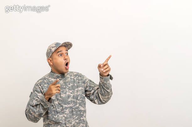 Pointing blank space. Asian man special forces soldier standing in ...