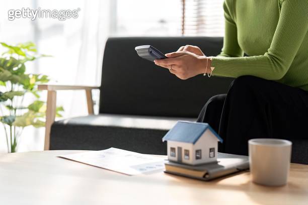 Woman renter using calculator for business financial accounting ...