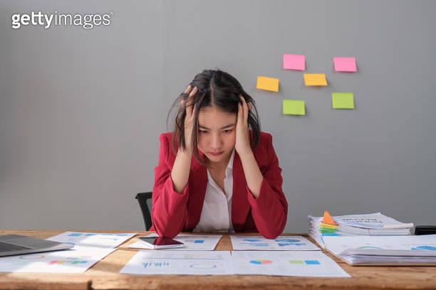 business woman sitting at work stressed , out working hard Feeling ...
