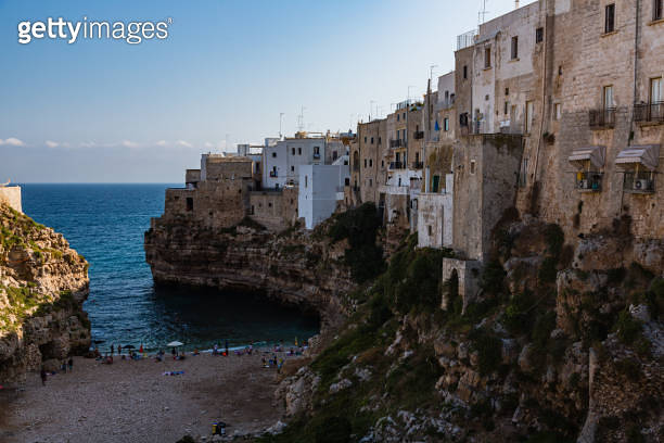 The townscape on the cliffs of the Cala Porto beach and the morning in ...