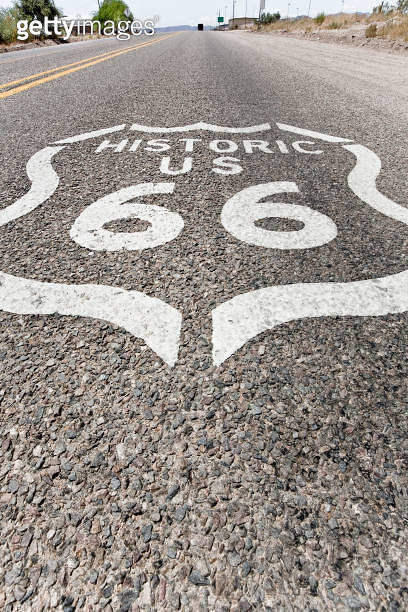 Historic Route 66 sign painted on asphalt of highway in Arizona ...