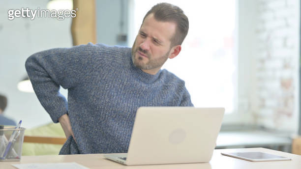Middle Aged Man having Back Pain while using Laptop 이미지 (1470491161 ...