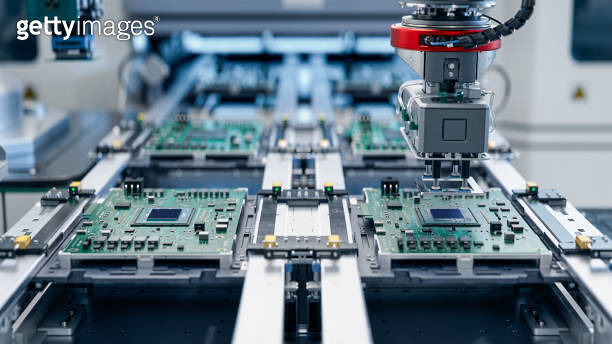 Component Installation on Circuit Board. Fully Automated Modern PCB Assembly Line Equipped with ...