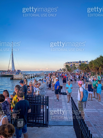 People at crowded Mallory Square in Key West, Florida watching sunset ...