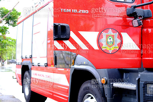 fire department's big red fire truck, emergency van on city street ...