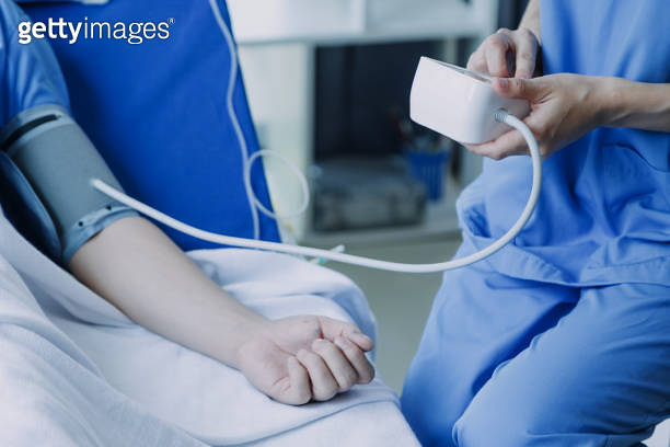 Side view of diverse doctors examining Asian female patient in bed in ...
