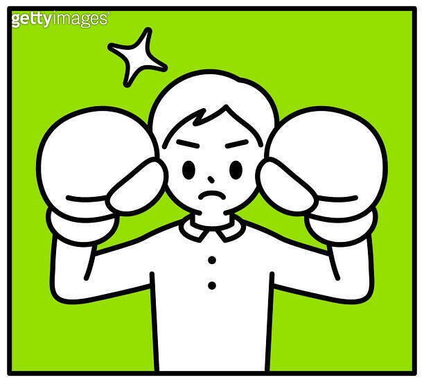 A boy in boxing gloves is ready to fight, looking at the viewer ...