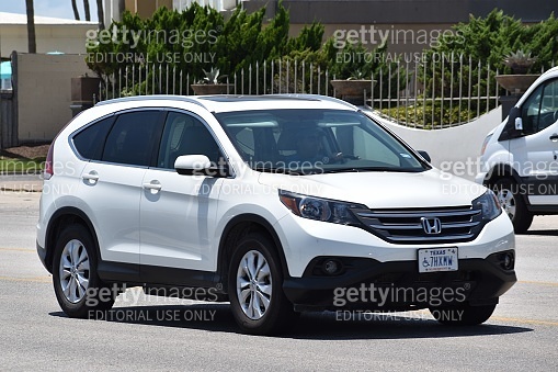 A white Honda mid-sized hatchback cruising on Seaway Blvd. at Galveston ...