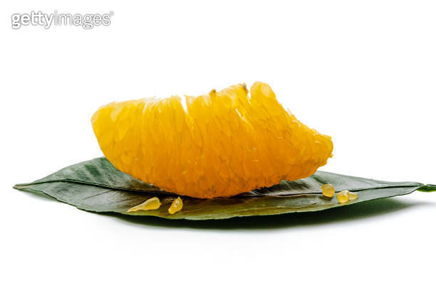 Peeled orange fruit pulp on green leaf isolated on white background ...