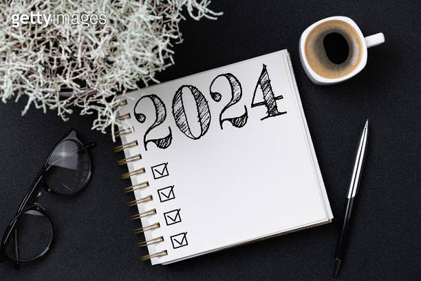 New year resolutions 2024 on desk. 2024 goals list with notebook ...