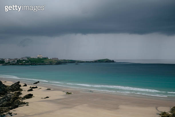 Low storm clouds with distant heavy rain over the sea at Newquay ...
