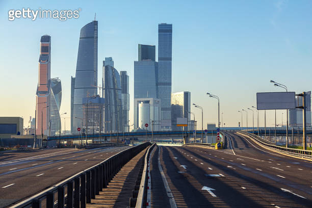An empty highway and modern business quarter Moscow city on the horizon ...