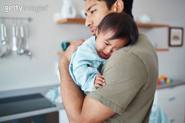 Crying, down syndrome baby and father holding, comforting and consoling ...