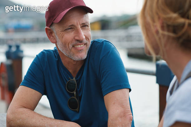 Man, woman and harbor with happy conversation on travel, vacation or ...