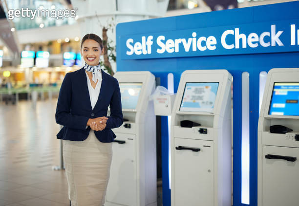 Woman, passenger assistant and airport by self service check in station ...