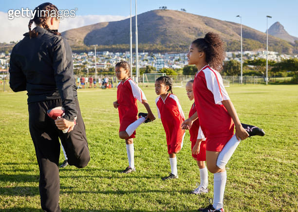 Soccer, team and stretching girl with coach on a sport field while ...