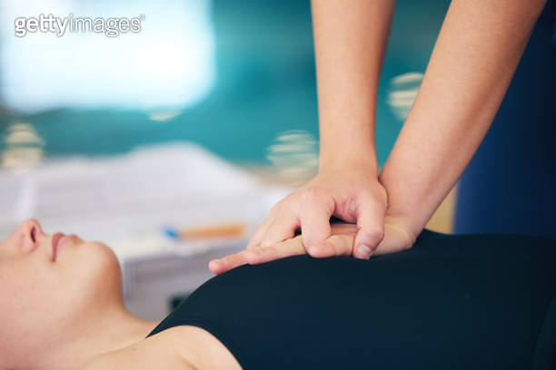 Pool, lifeguard and chest compression on drowning victim, emergency ...